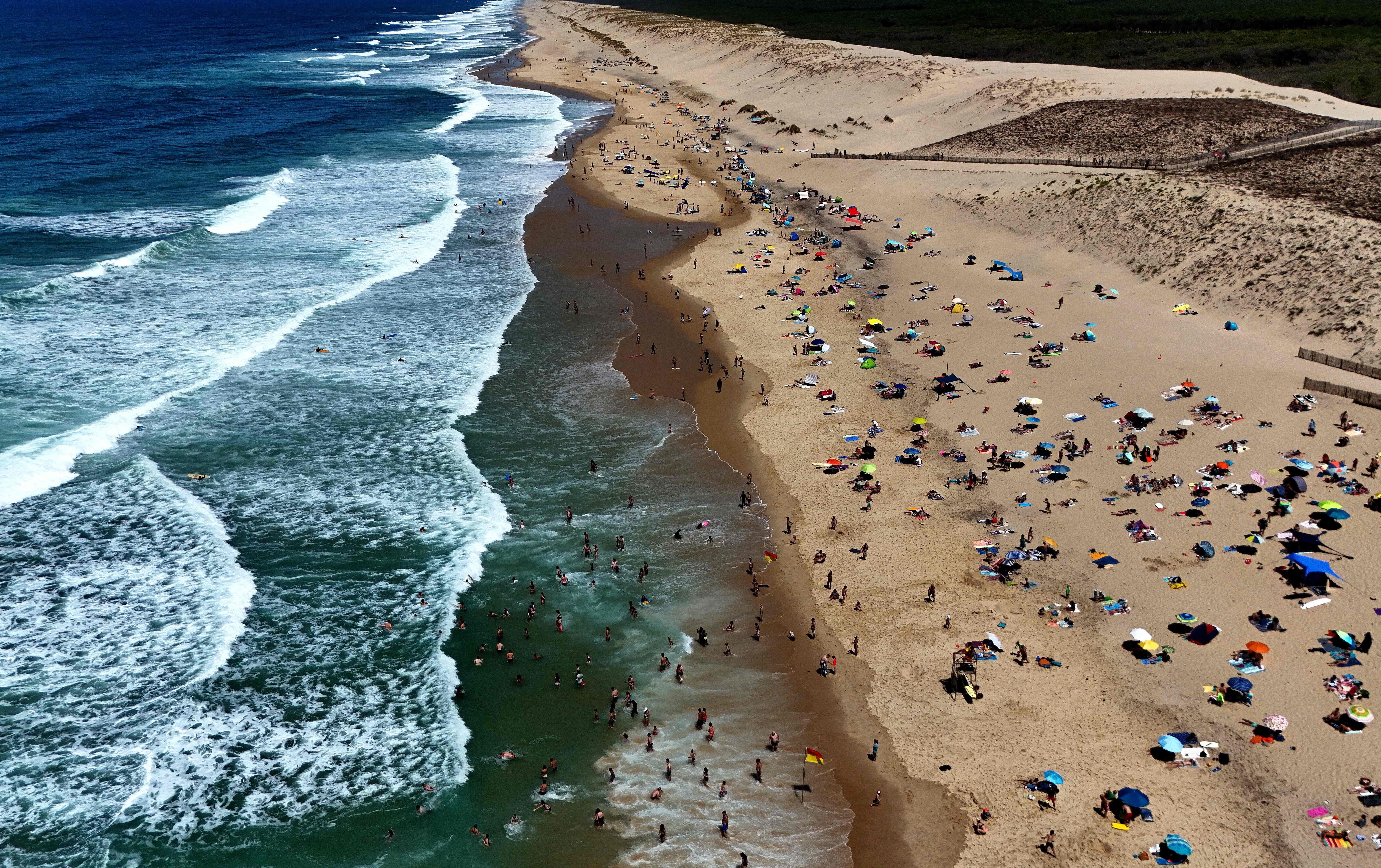 Best photos of July 24: Beachgoers in France to kids playing in a ...