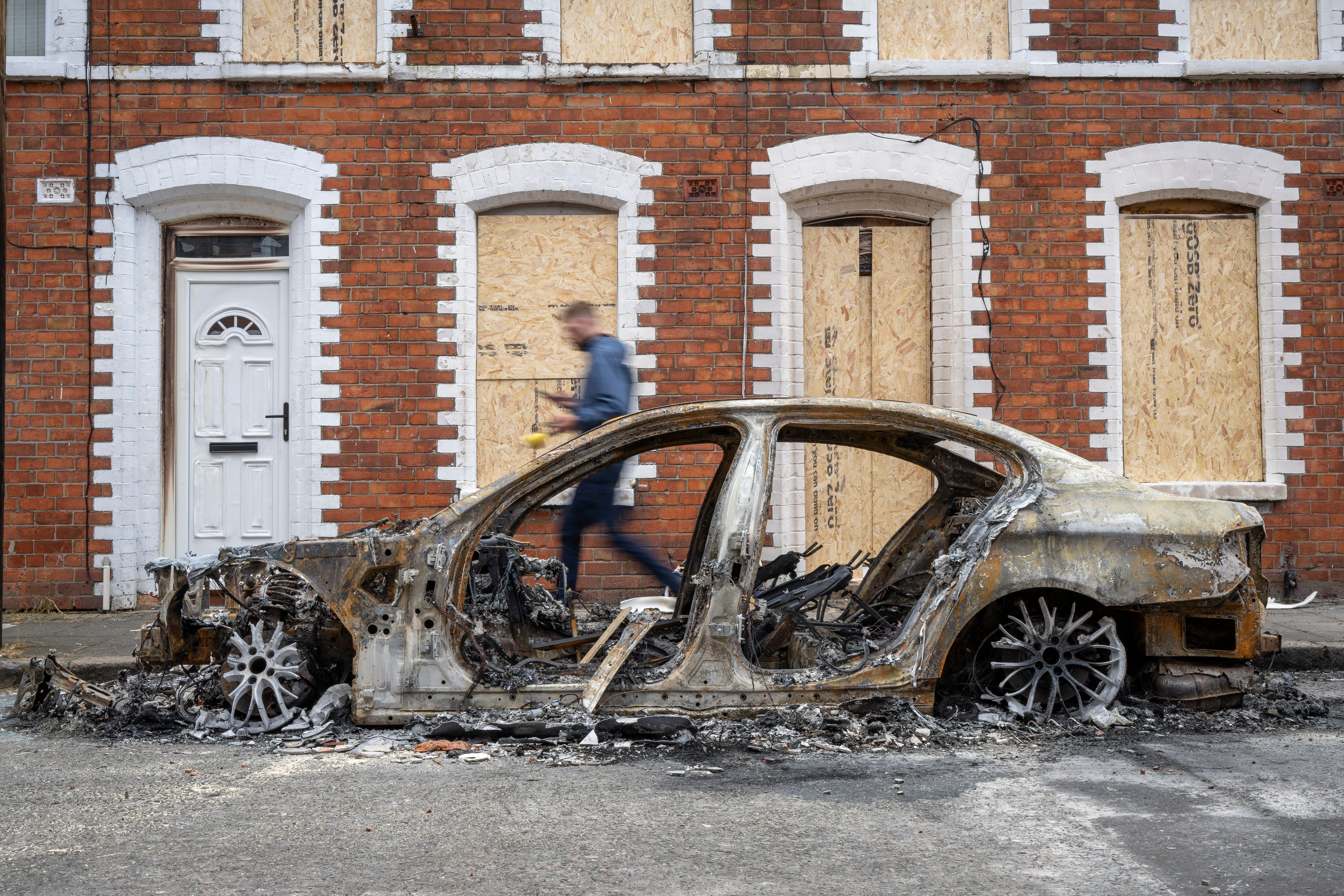 Masked rioters 'burn foreigners out of their homes' in wake of Belfast ...